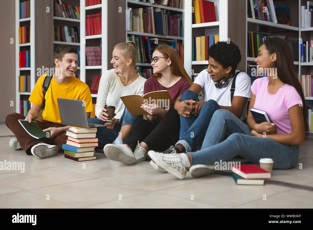 Group of teenage students making homework and smiling Stock Photo - Alamy