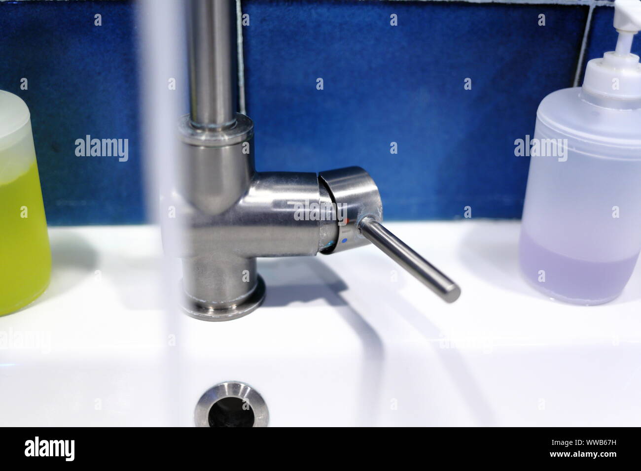 Washbasin tap with stainless steel waste Stock Photo - Alamy