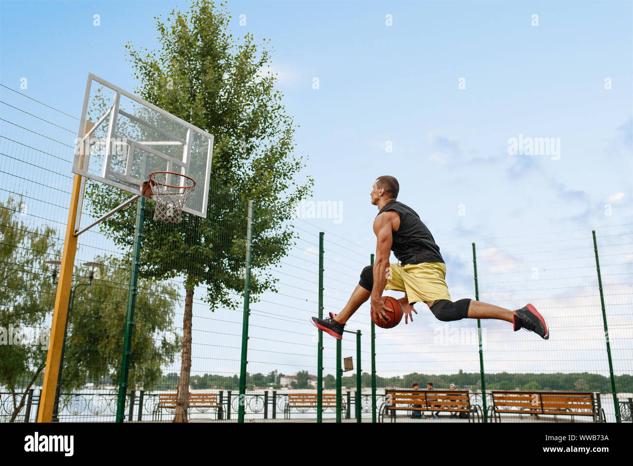 Basketball player makes a throw in jump, outdoor Stock Photo - Alamy