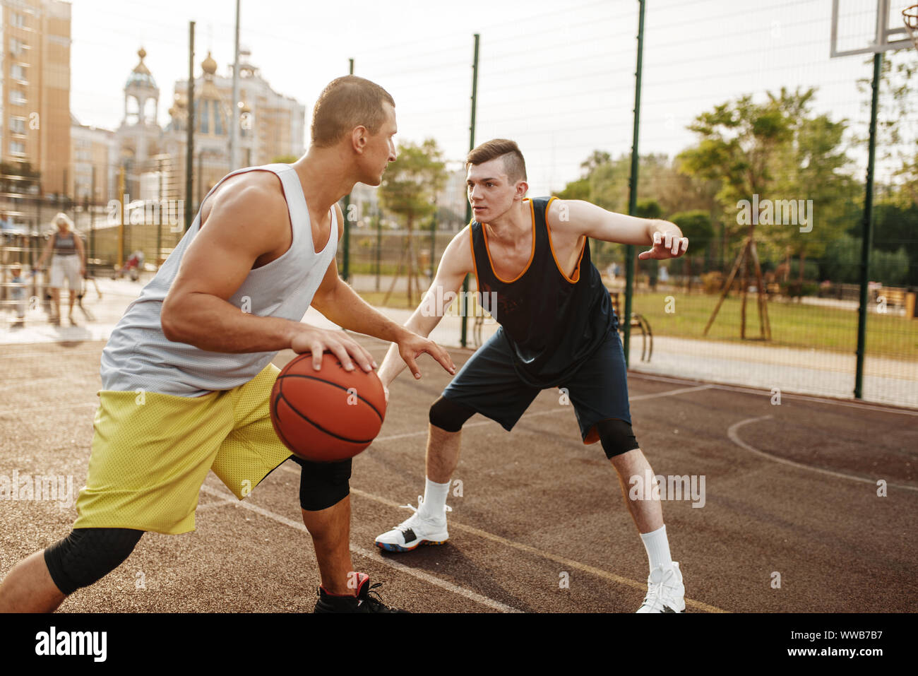 Basketball players playing intense match outdoor Stock Photo - Alamy