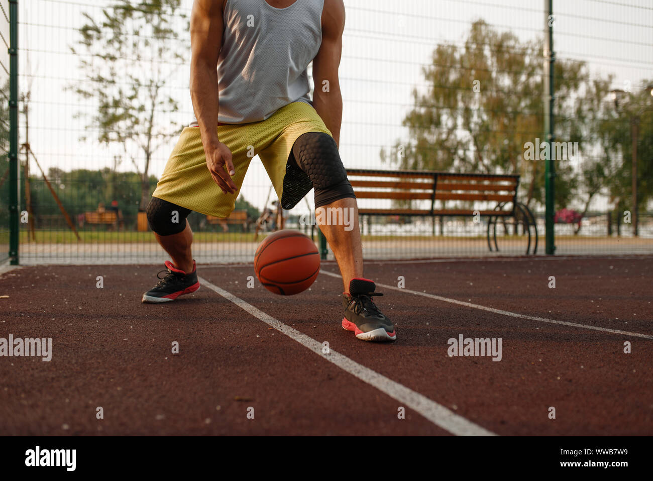 Male basketball player with ball shows his skill Stock Photo - Alamy