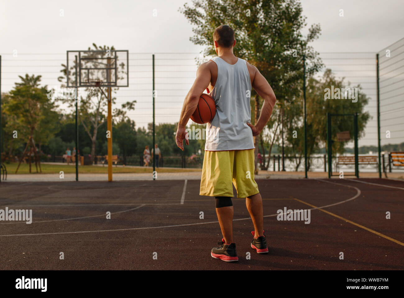 Muscular basketball player on outdoor court Stock Photo - Alamy