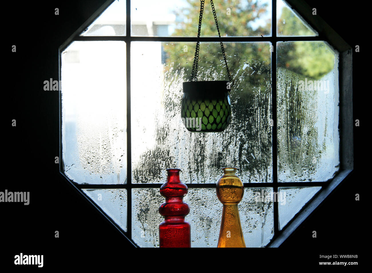 Colorful decorative objects at house window Stock Photo - Alamy