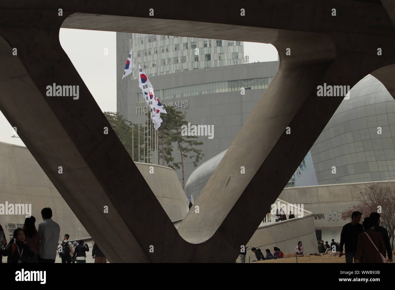 National flags are waving in the breeze framed by triangular columns of ...
