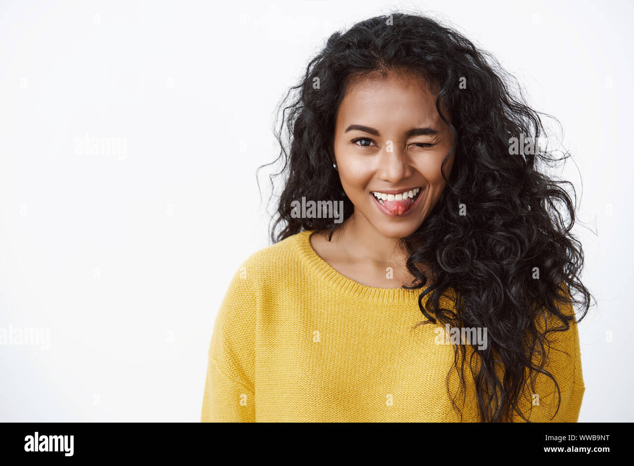 Funny, enthusiastic african american curly-haired girl in yellow autumn ...