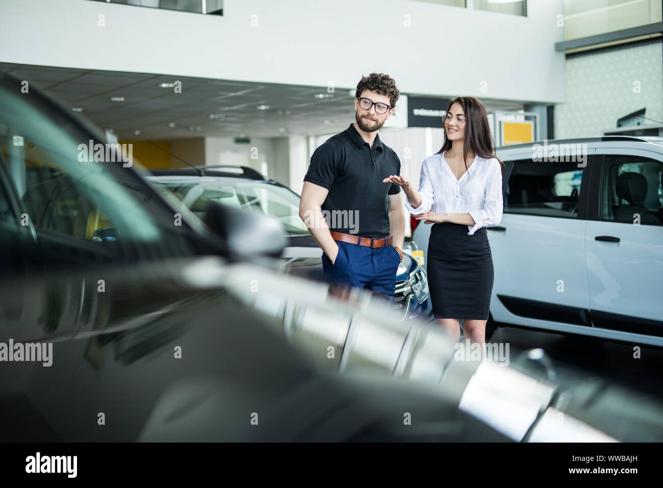 Professional salesperson selling cars at dealership to buyer Stock ...