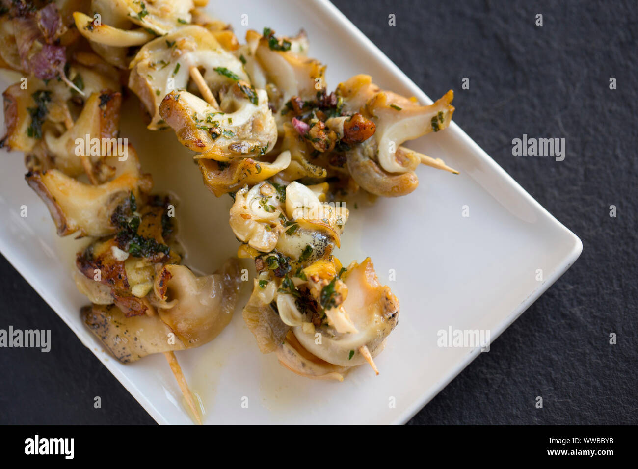 Whelks, Buccinum undatum, that have first been boiled and then cut in ...