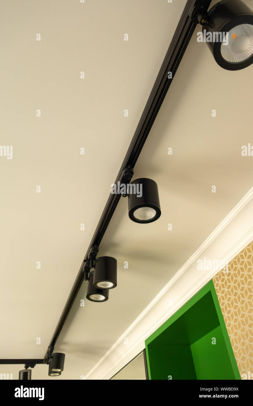 Modern LED lights in black on the mounting rail Stock Photo - Alamy