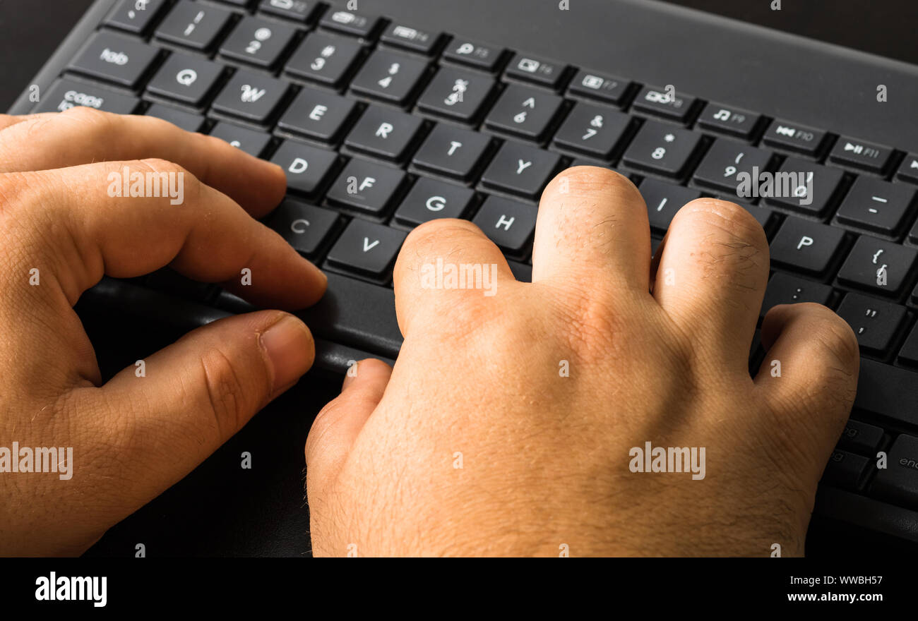 Male hand using pc keyboard. Close up man hand on computer keyboard on ...