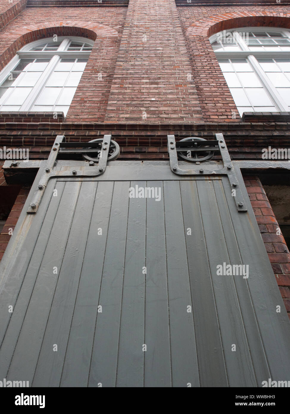 Solid Heavy Door In A Brick Building Stock Photo - Alamy