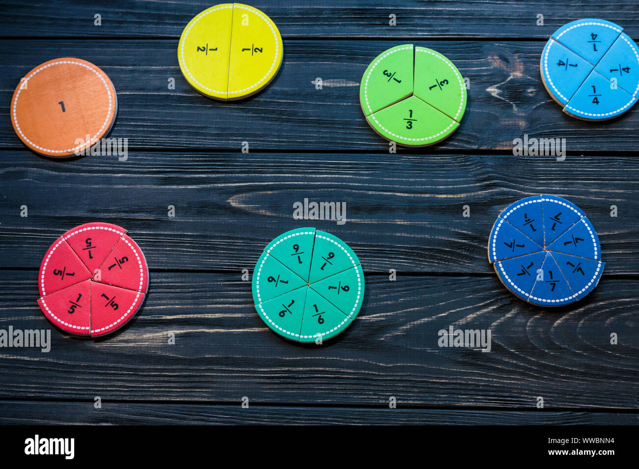 Colorful math fractions on wooden background or table. interesting math ...