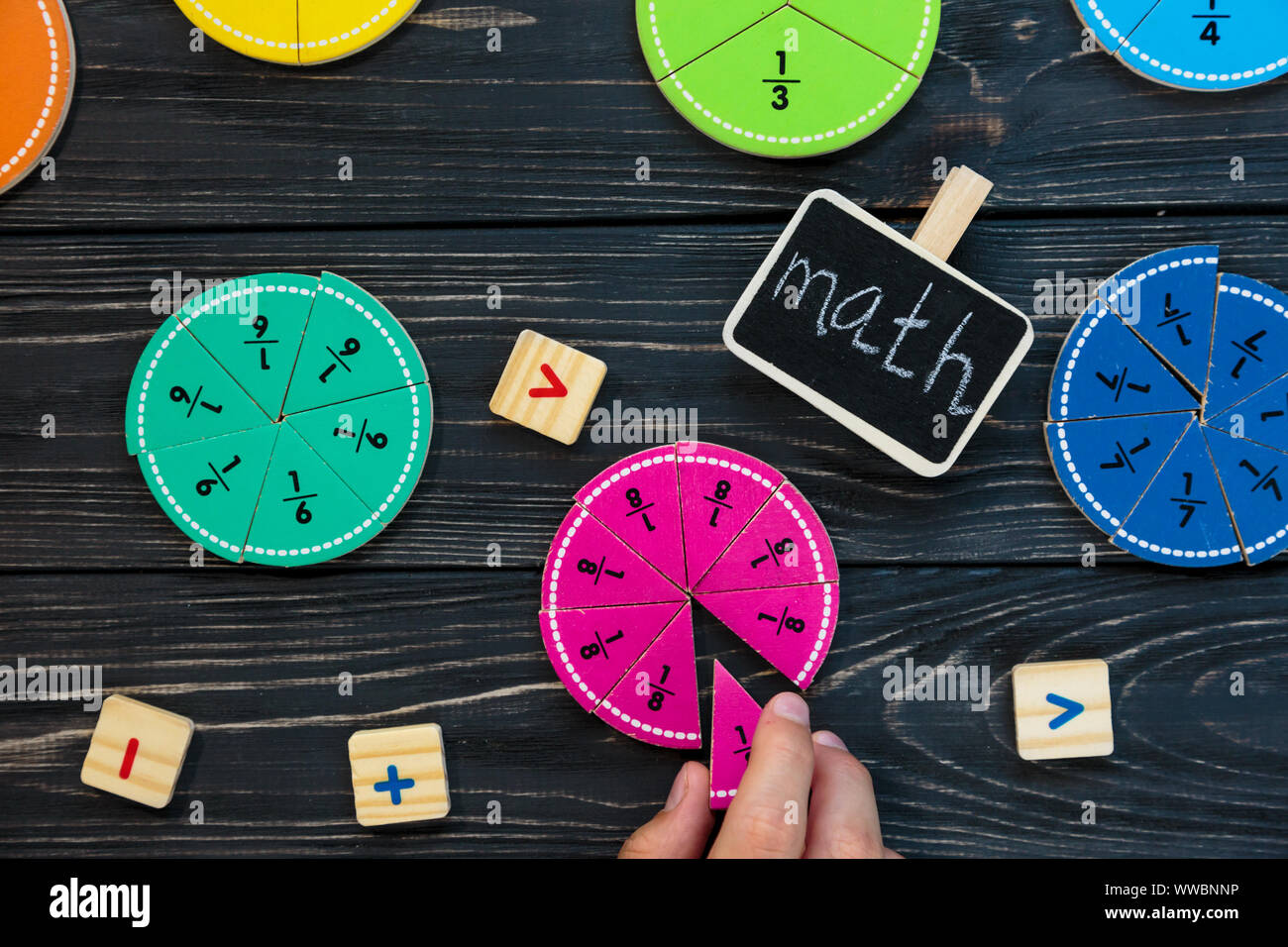 Colorful math fractions on wooden background or table. interesting math ...