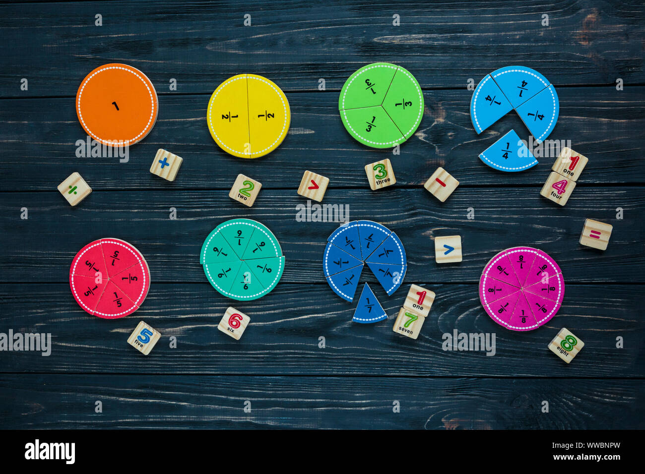 Colorful math fractions on wooden background or table. interesting math ...