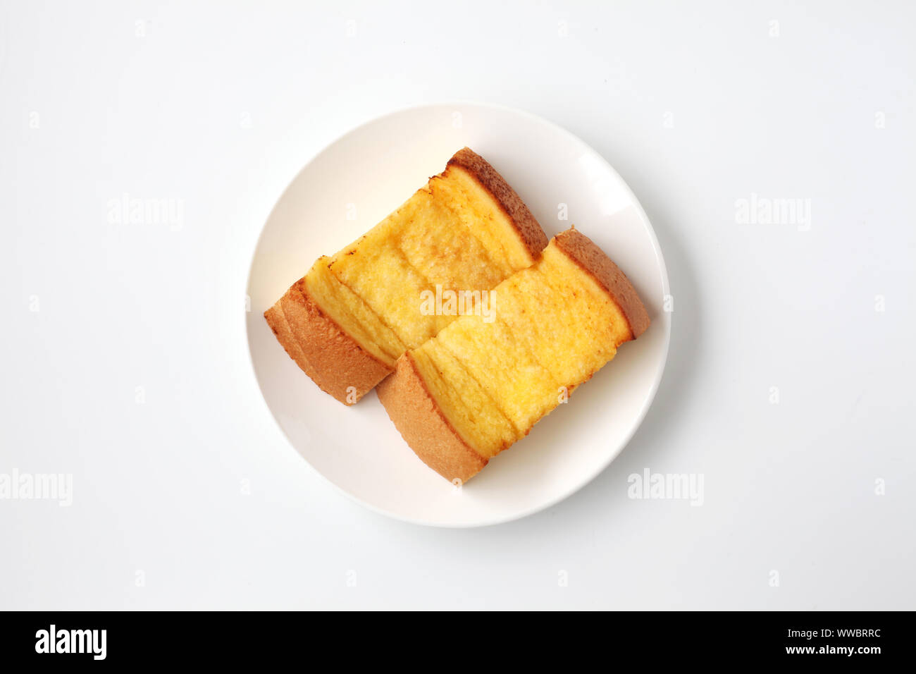 2 pieces of french toast on plate closeup isolated on white background ...