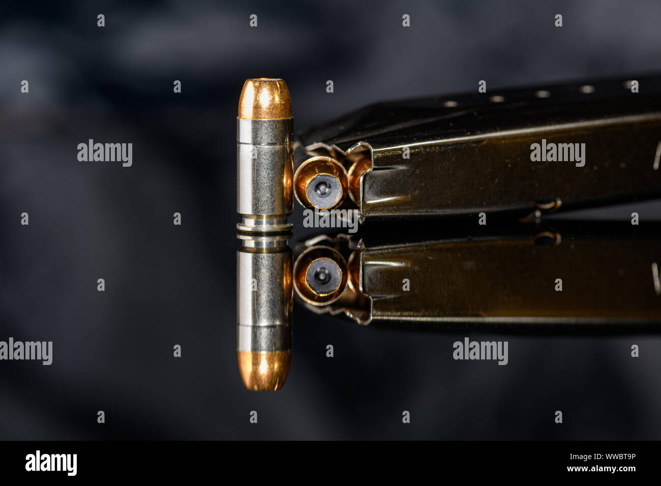 40 Caliber ammunition with magazine on black background Stock Photo - Alamy