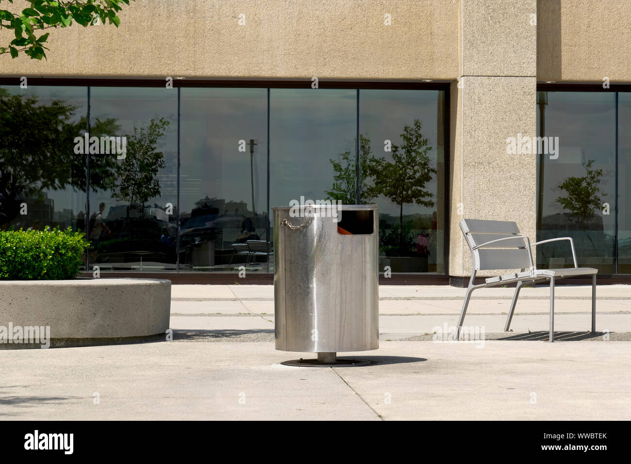Stainless Steel Garbage Can and Chair in Front of Tinted Windows ...