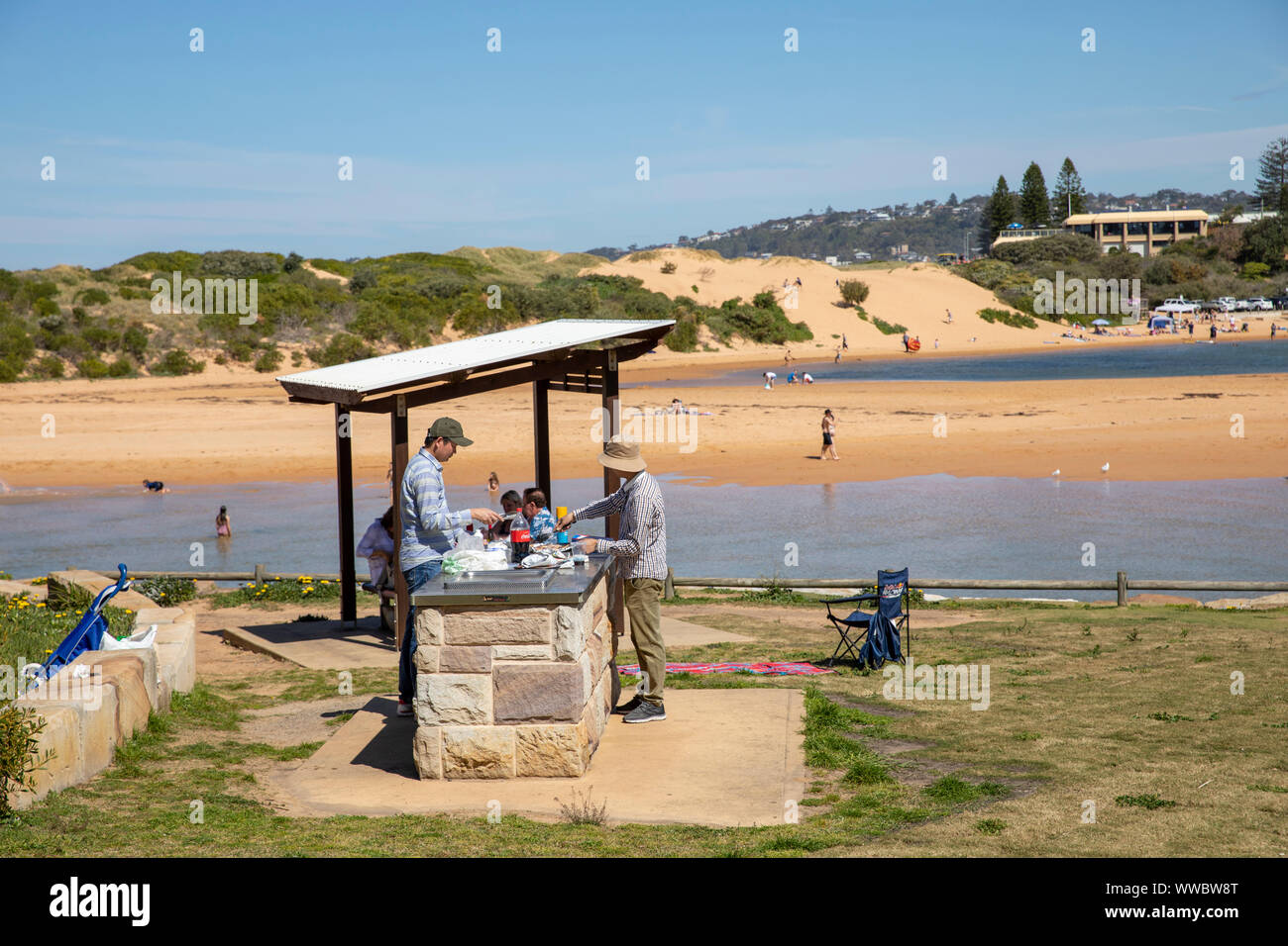 Two australian men cooking on a beach BBQ barbecue barbecue in ...