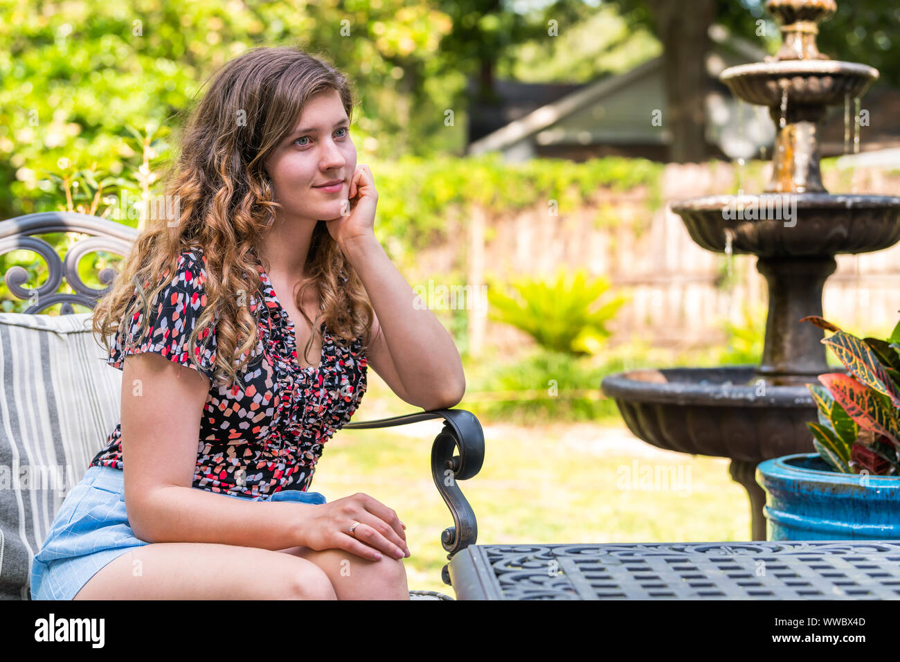 Beautiful woman sitting patio table hi-res stock photography and images ...