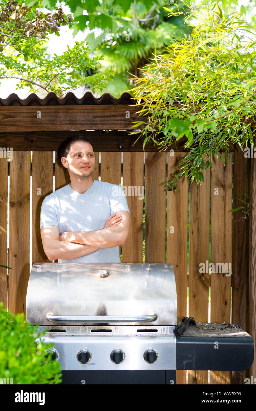 Barbeque modern new grill in outdoor summer backyard garden during day ...