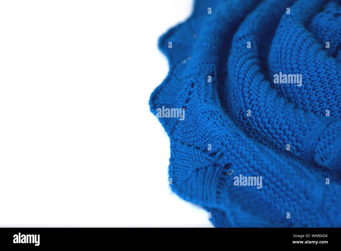 Azure blue crochet sweater on white background. Texture detail close up ...