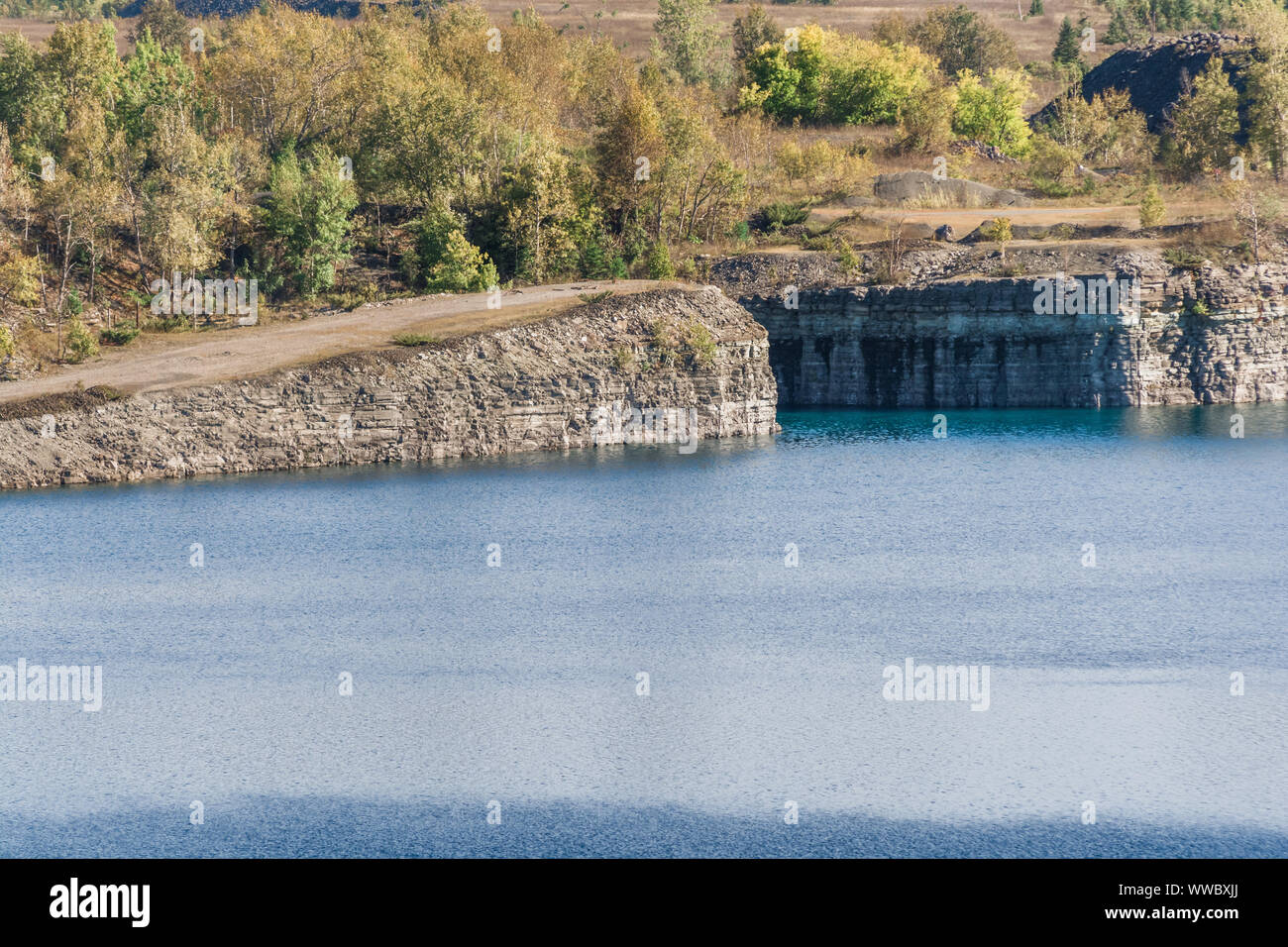 Close up of rocky wall strata showing different layers of green and ...