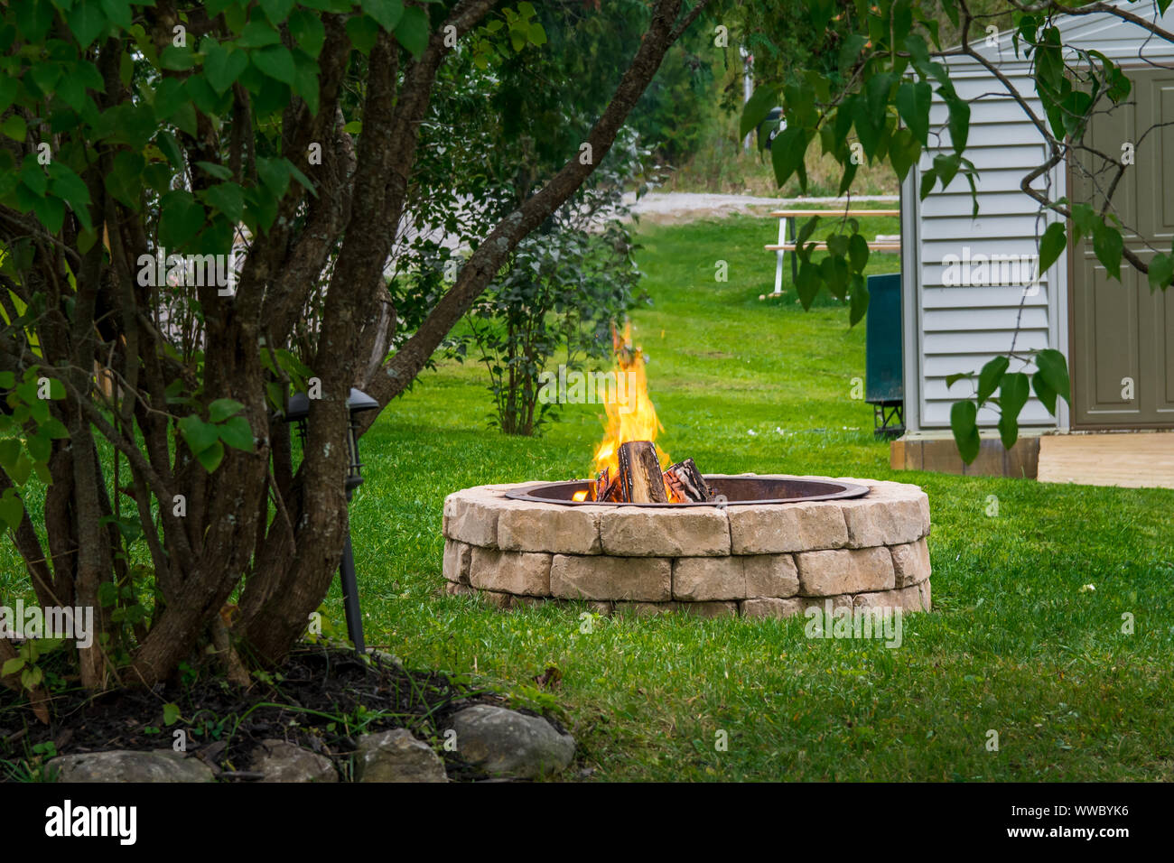 Cottage country scene showing fire place with burning wood Stock Photo ...