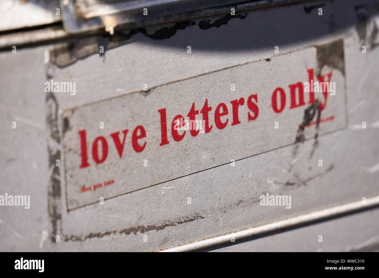 A sticker reading "love letters only" is attached to a post box in ...