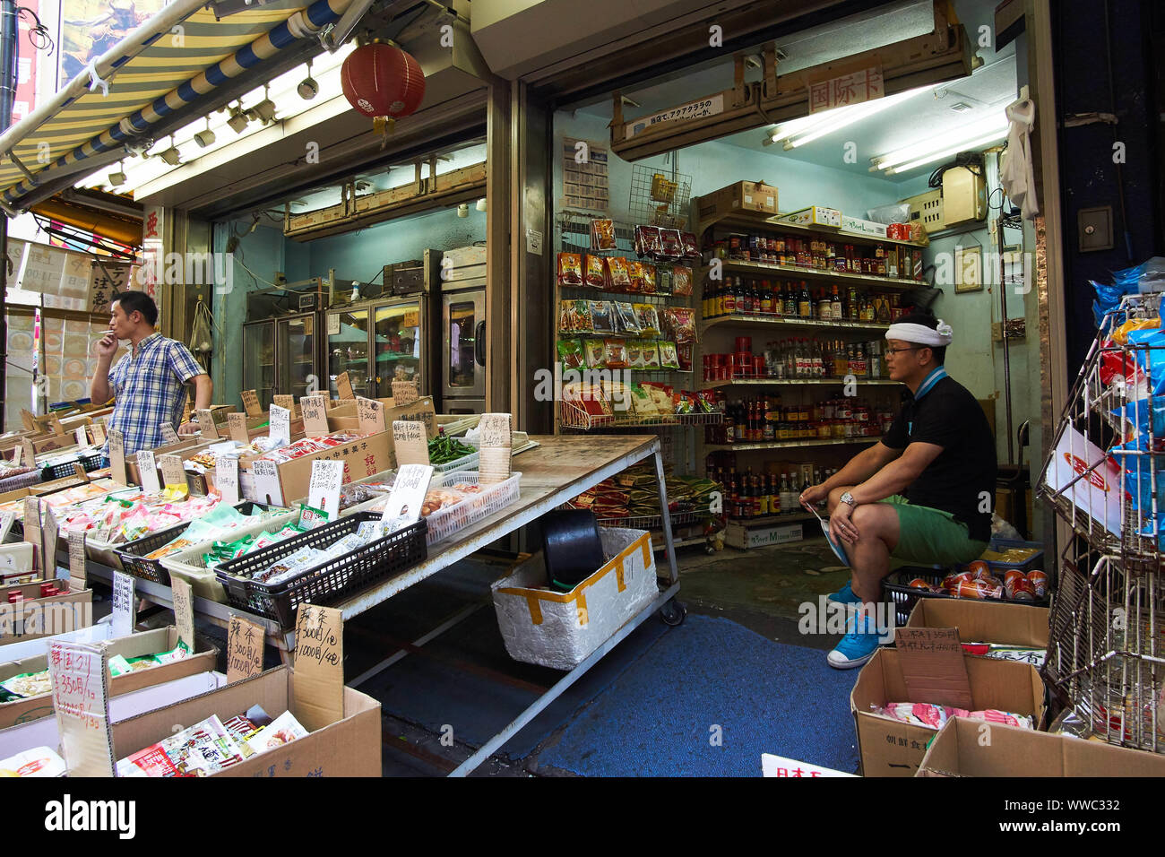 Two adult male Japanese shopkeepers at their outdoor shop in Ueno's ...