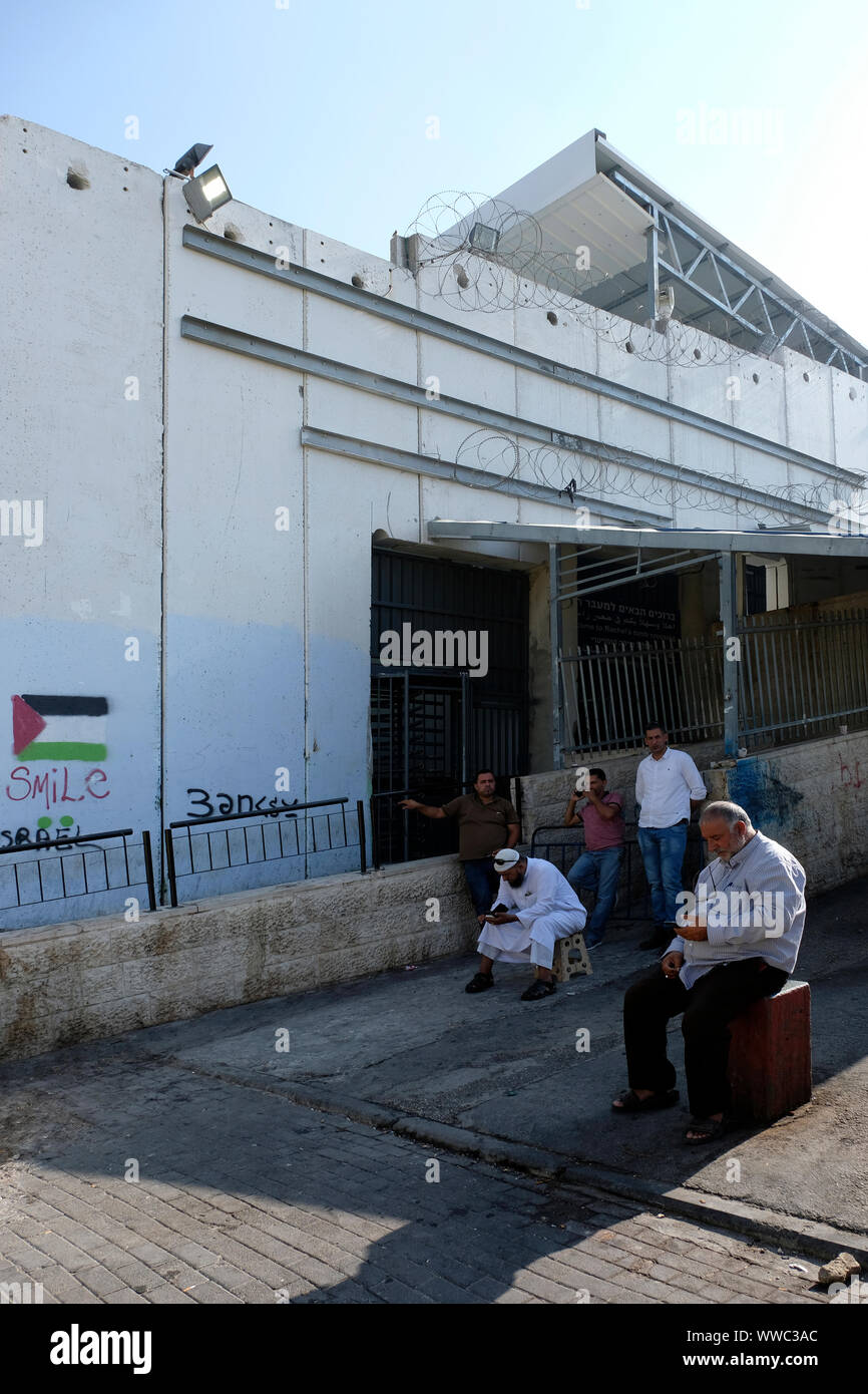 Palestinians wait outside the main entrance to Bethlehem which is ...