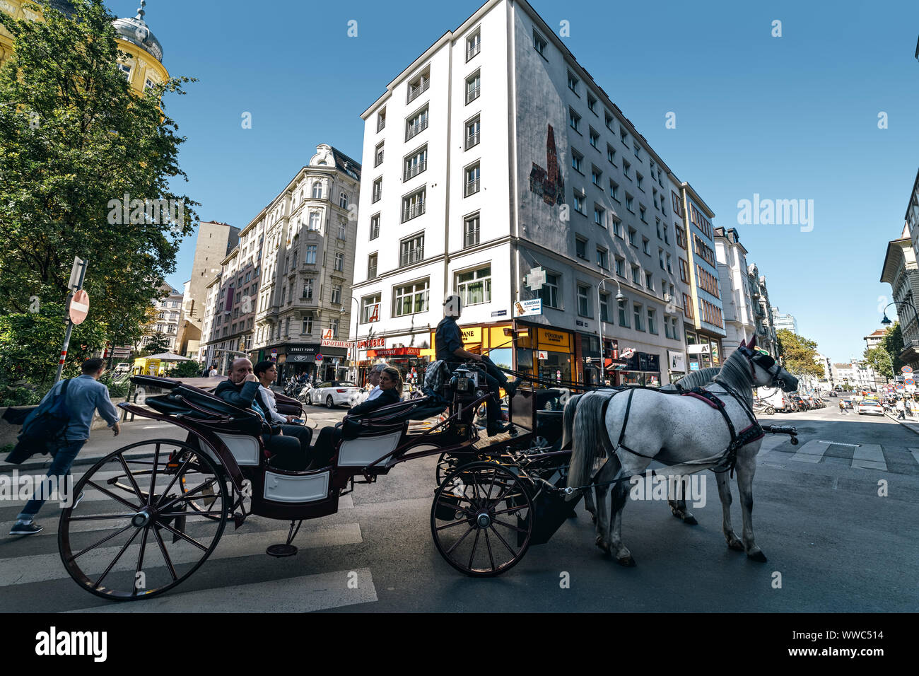 People sitting in open carriage during city tour in the city center of ...