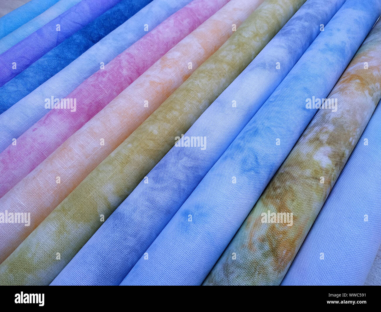 Rolls of colorful fabrics. Dyed fabric for sewing. Cross stitch fabric ...