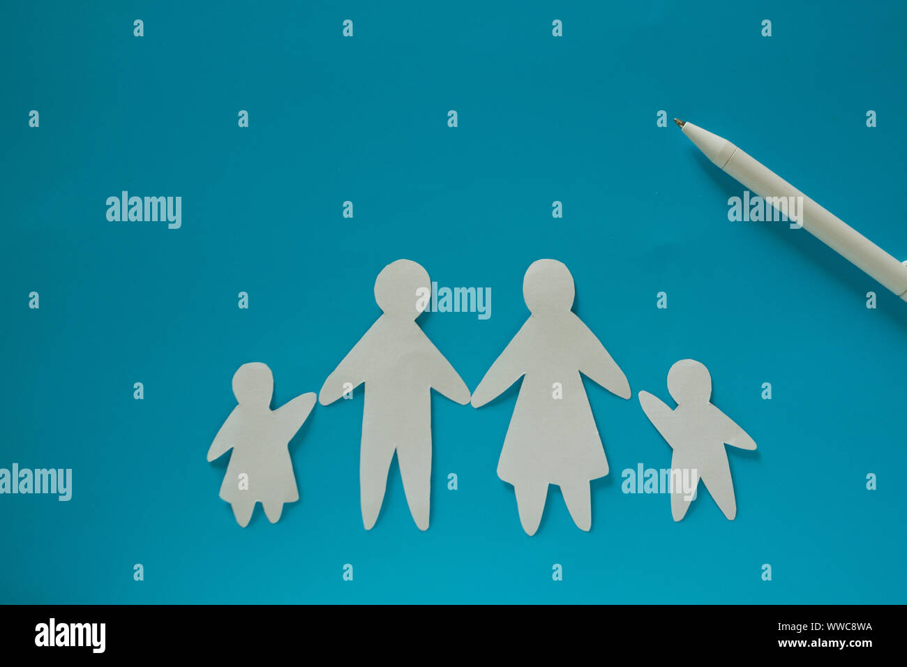 Paper family on blue background with copy space Stock Photo - Alamy