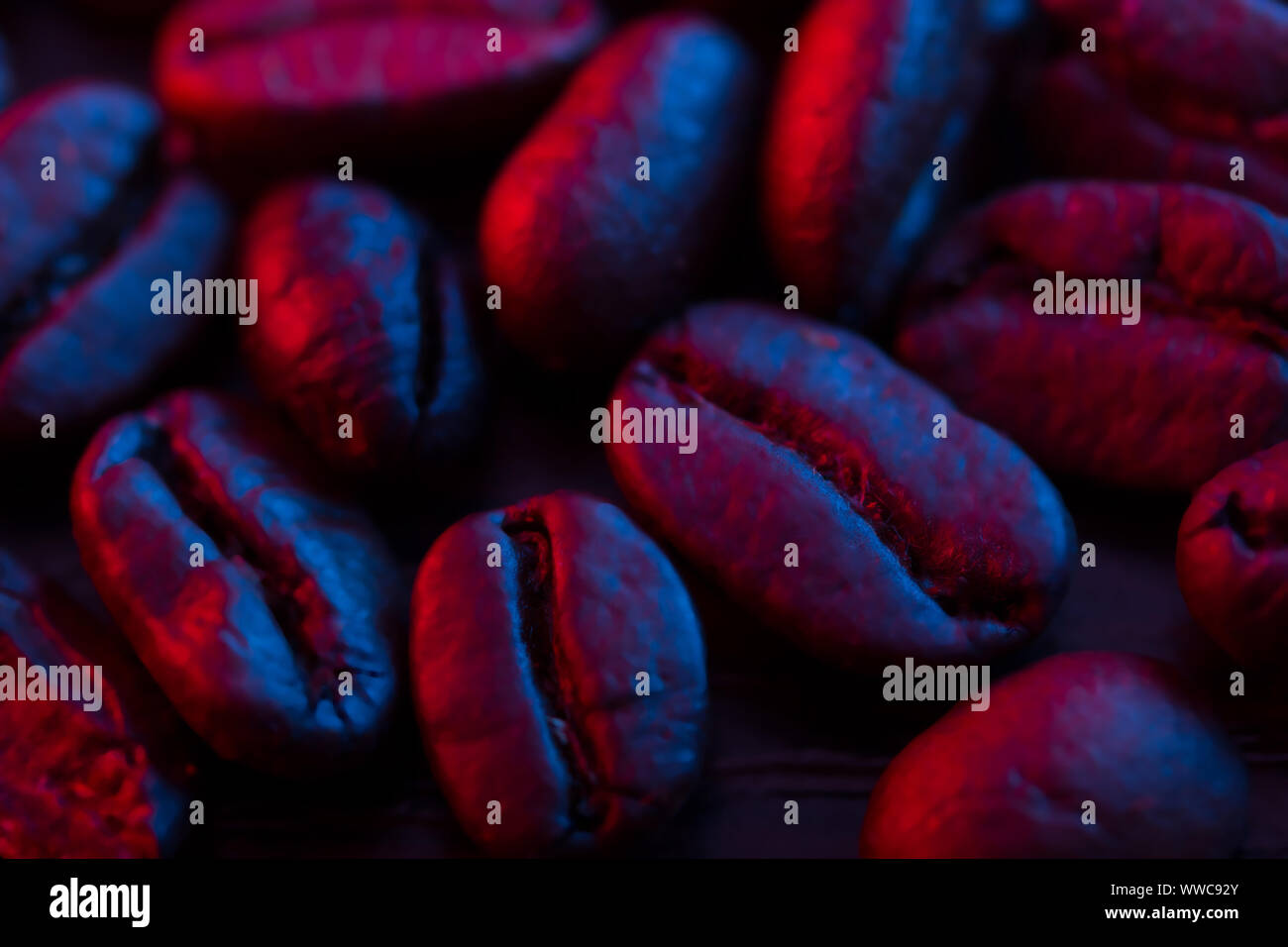 Roasted coffee bean close up in neon light Stock Photo - Alamy