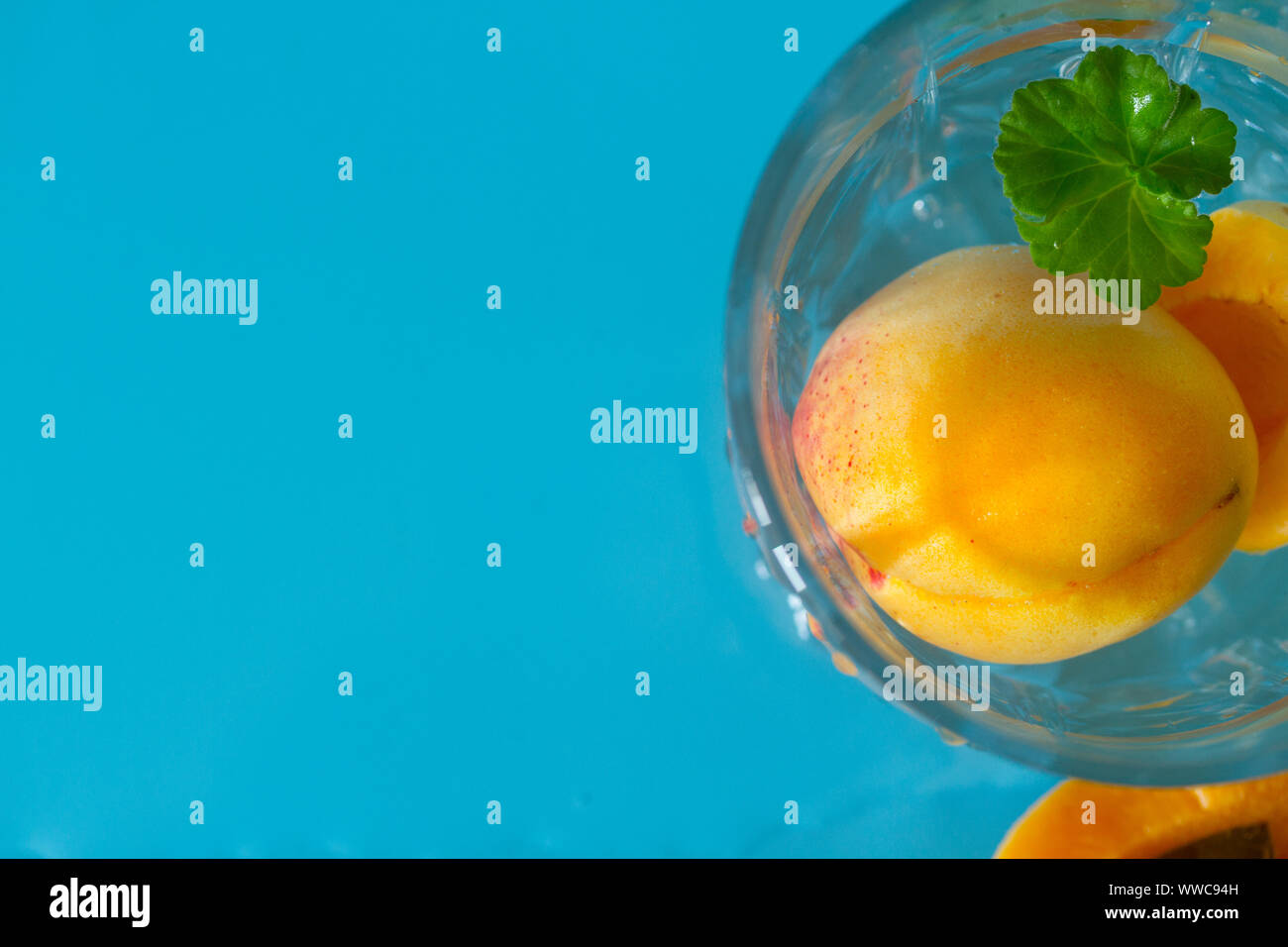 ripe apricots on the blue background. natural light Stock Photo - Alamy