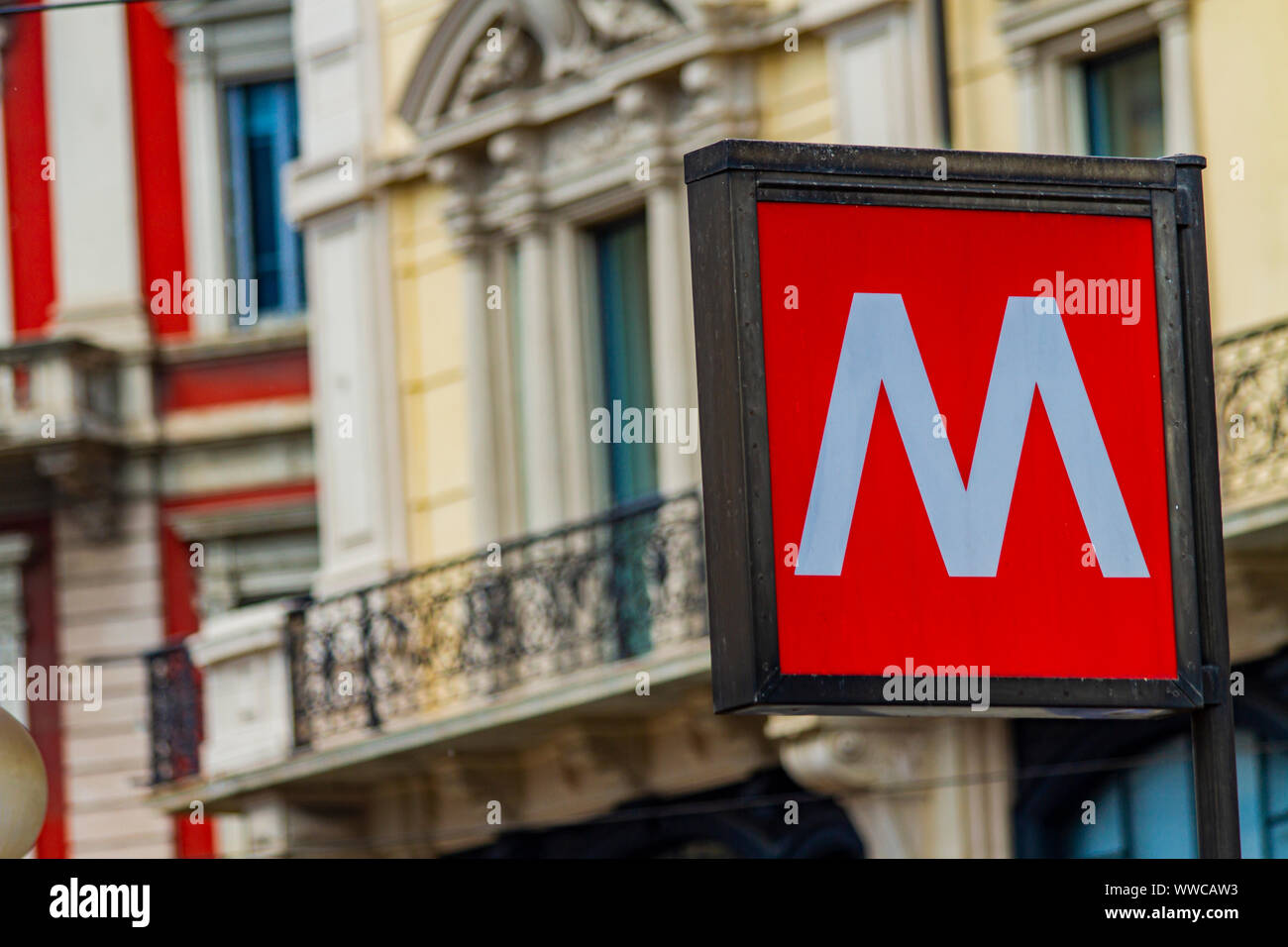 Traditional Milan metro sign on the backdrop of a beautiful old ...