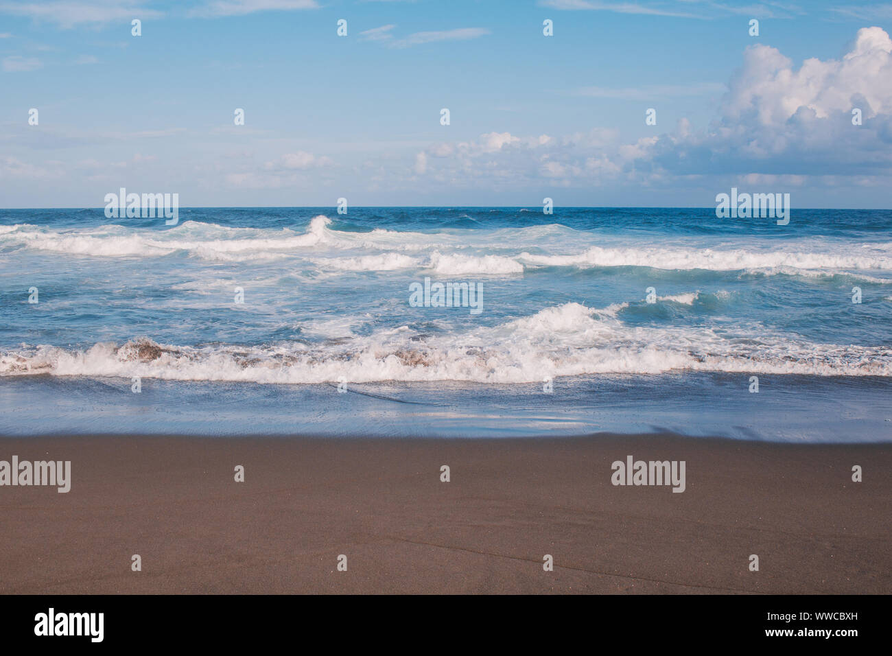 beautiful blue ocean and black sand beach on the Azores, in Portugal ...