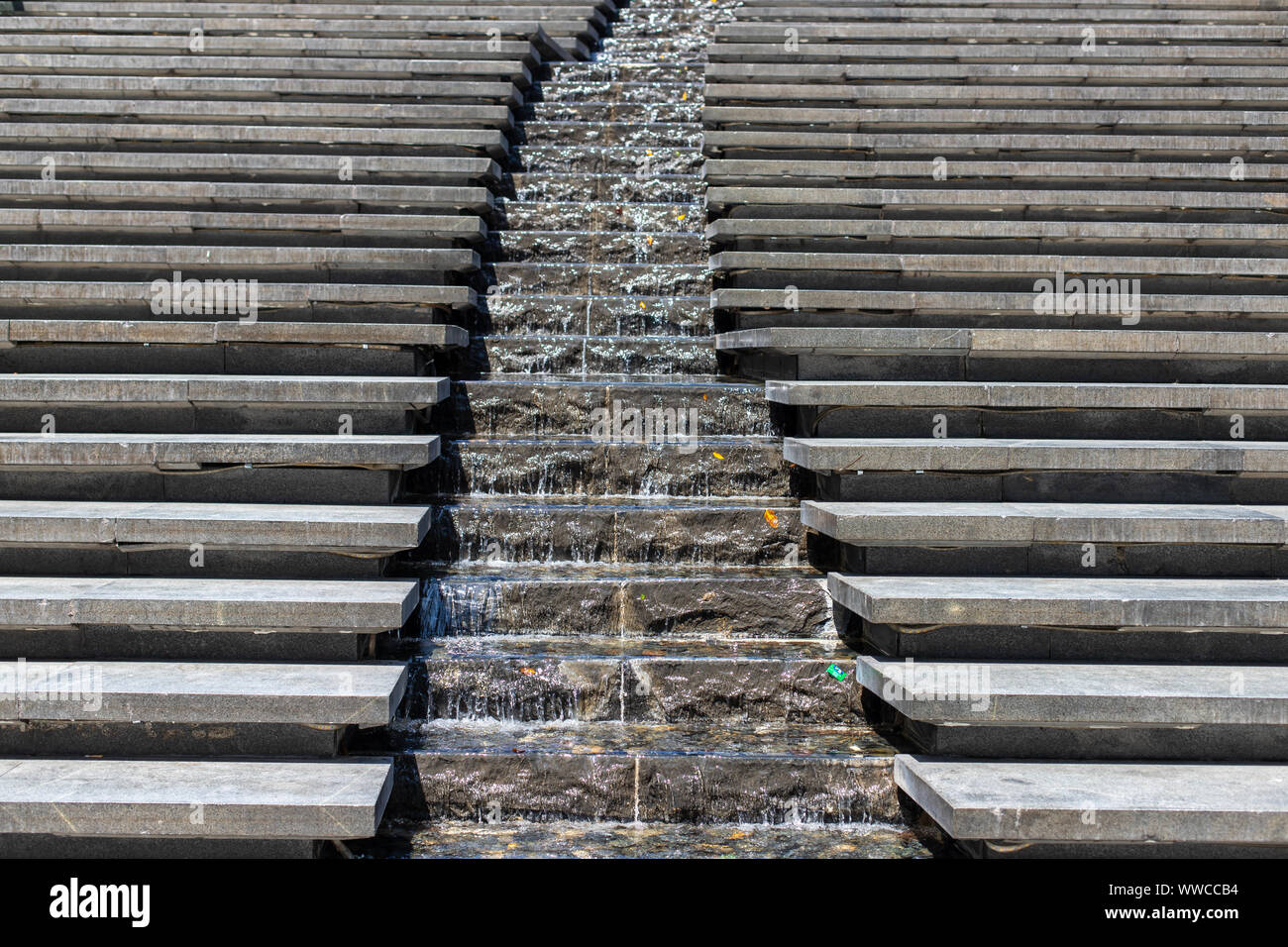 City stream. Water cascade. Steps down and in the middle, water flows ...