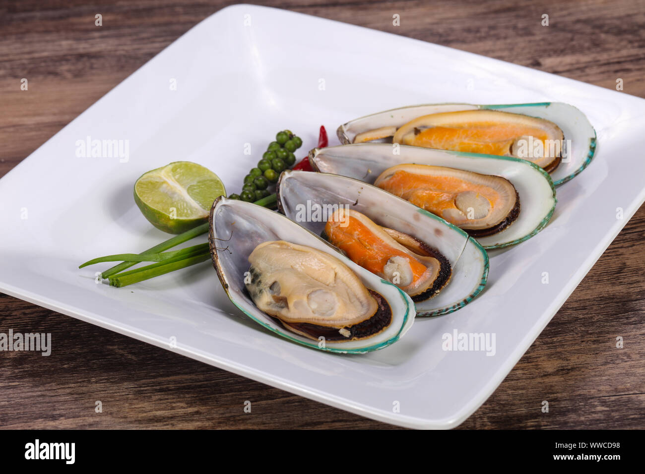 Half mussels with lime and green pepper Stock Photo - Alamy