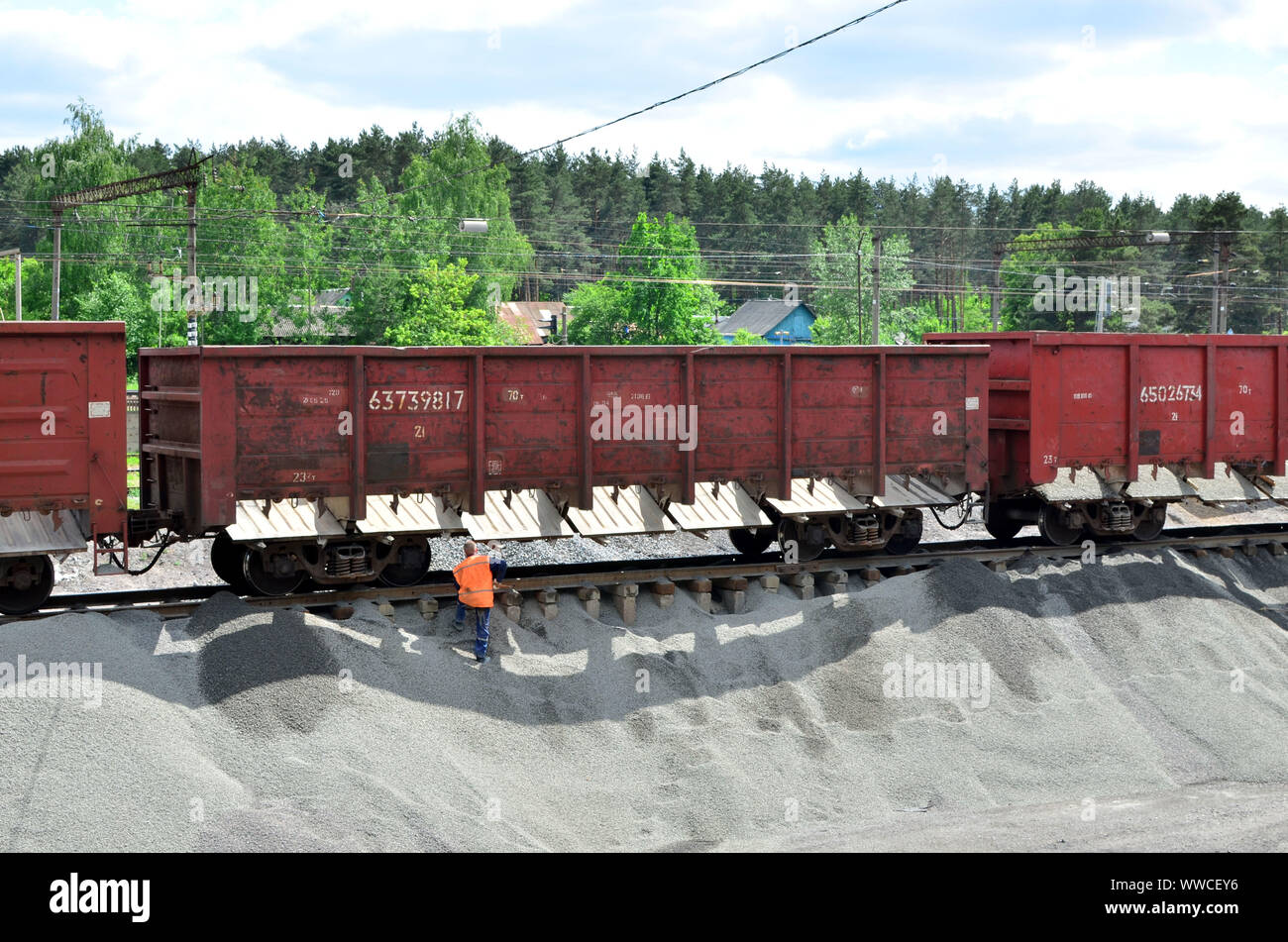 Unloading of crushed stone from railway car. Unloading bulk cargo from ...