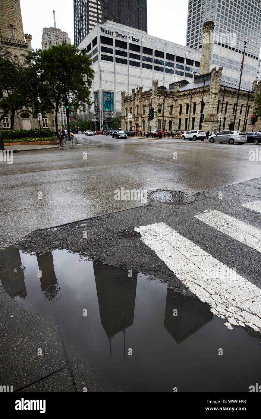 reflection of john hancock tower 875 north michigan in rainwater puddle ...