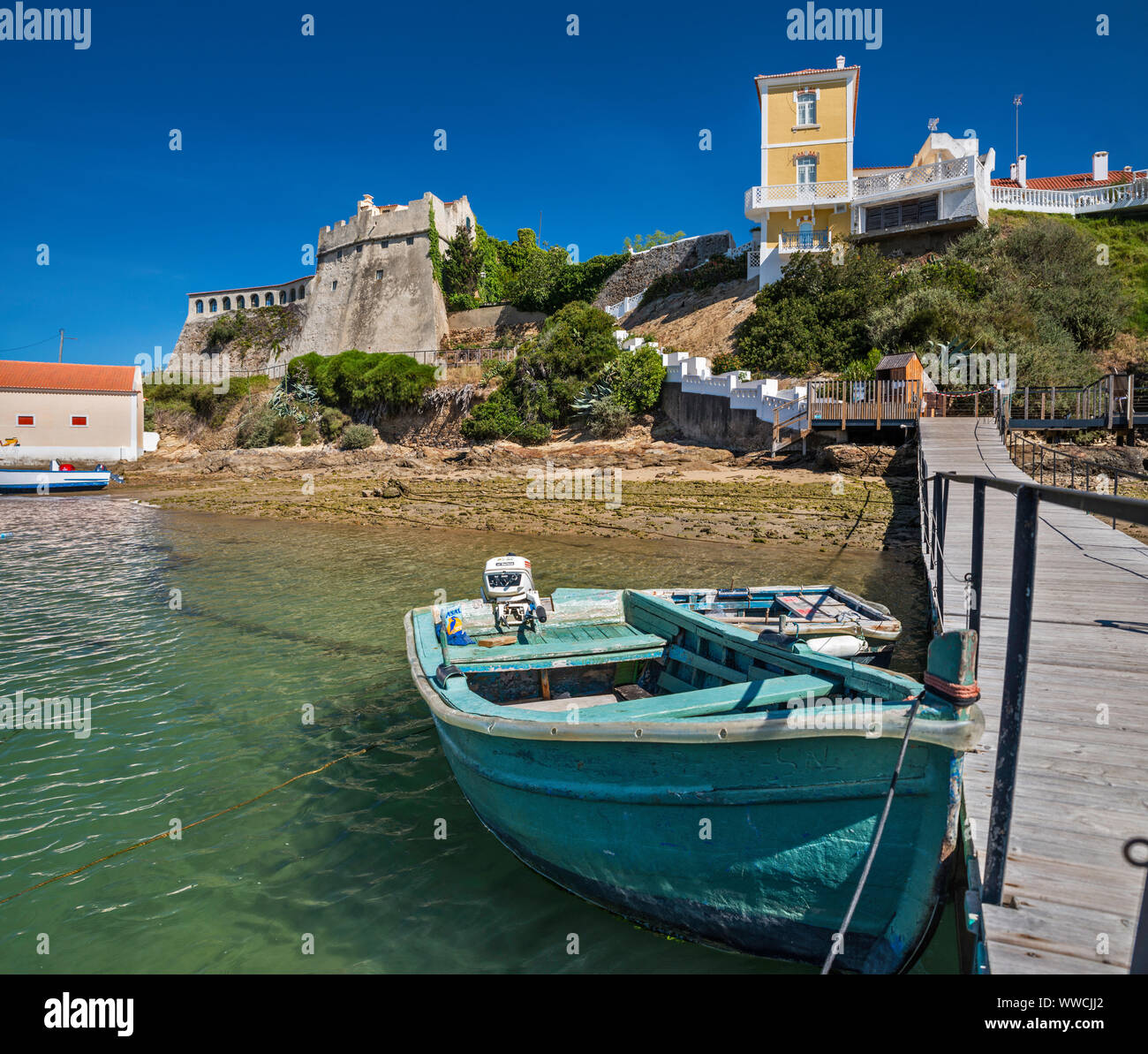 Boat at Rio Mira, Forte de São Clemente, 16th cent castle, town of Vila ...
