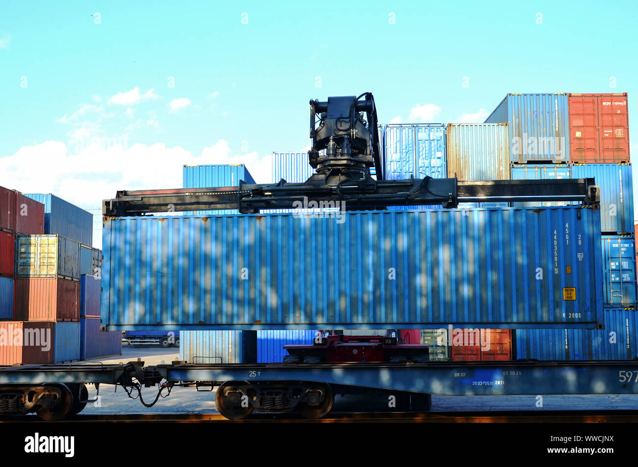 Shipping container loading by richtracker on the freight rail car at ...