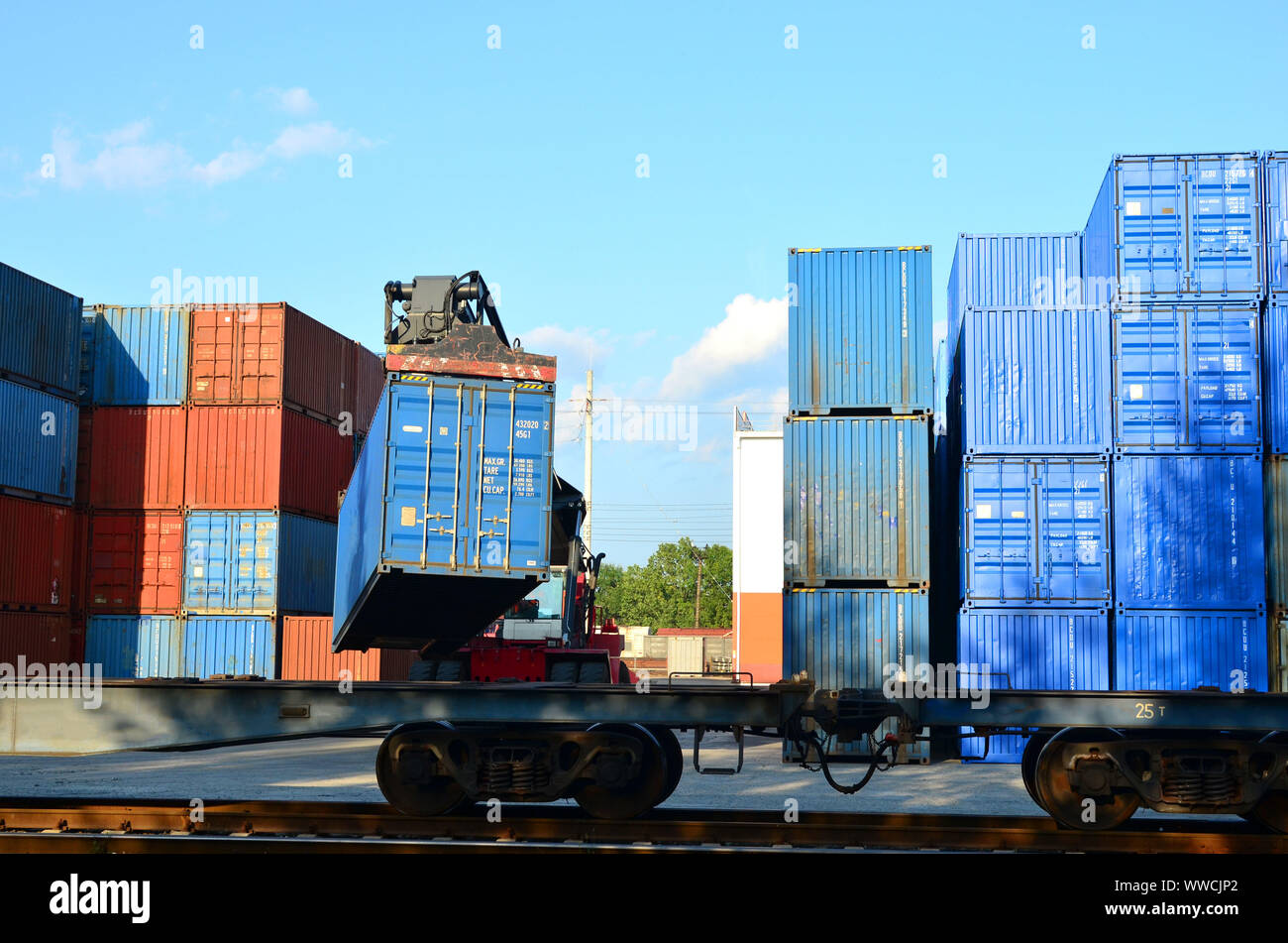 Shipping container loading by richtracker on the freight rail car at ...