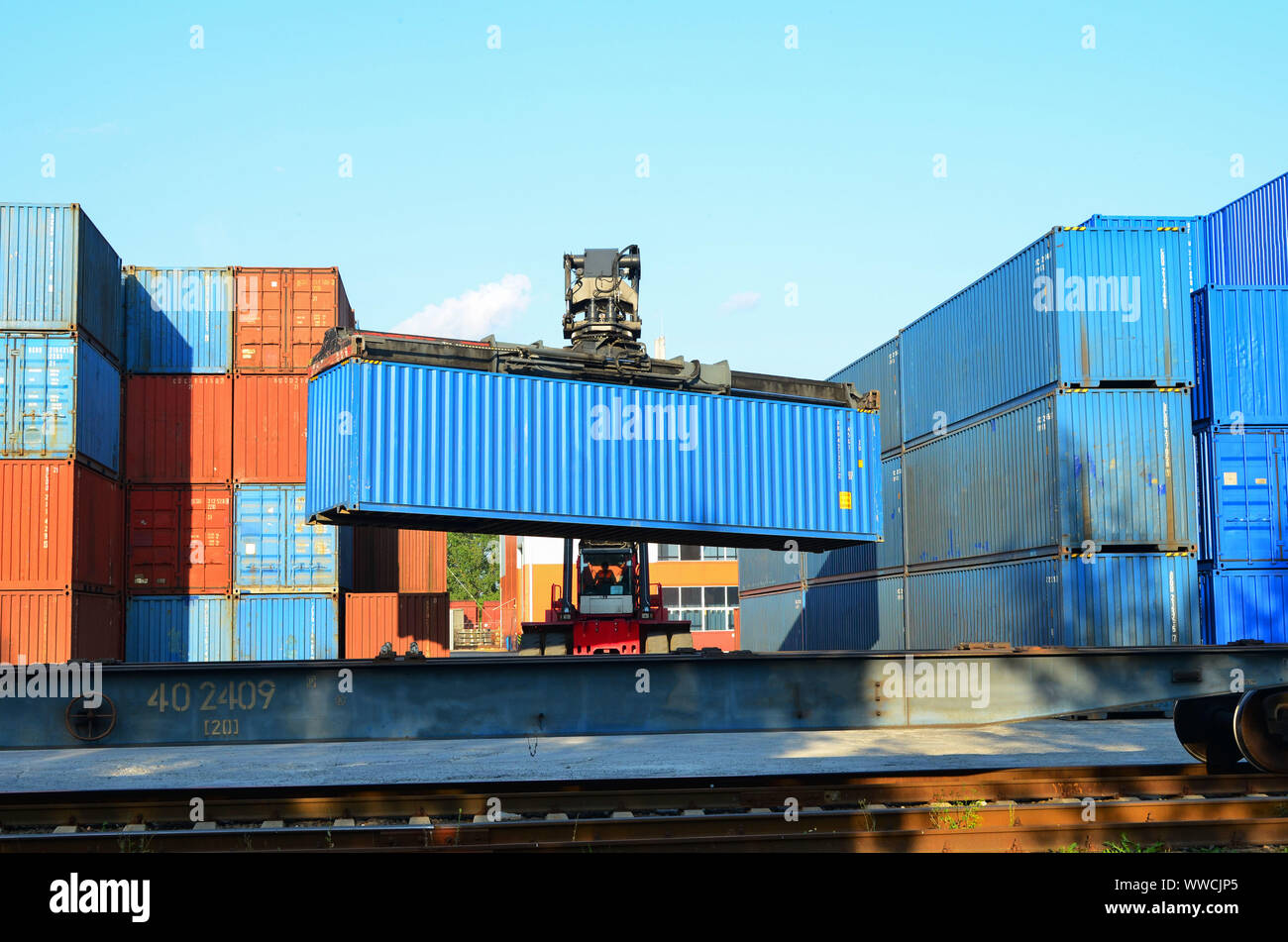 Shipping container loading by richtracker on the freight rail car at ...