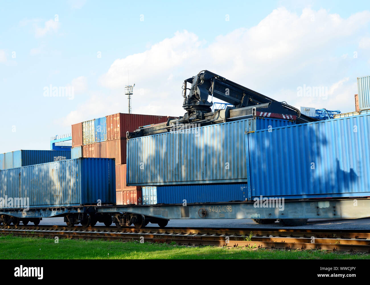 Shipping container loading by richtracker on the freight rail car at ...