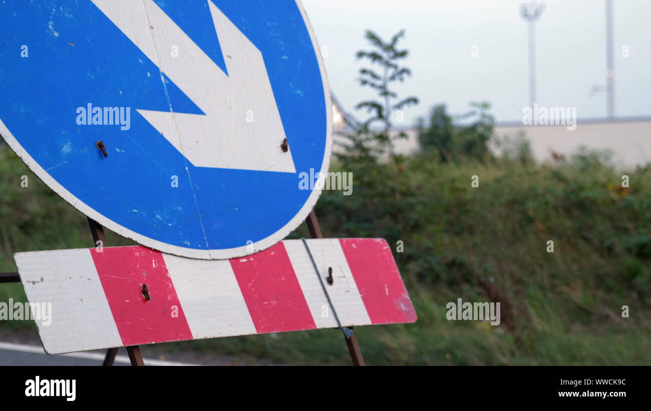 roadworks directional arrow sign on UK motorway at evening with traffic ...