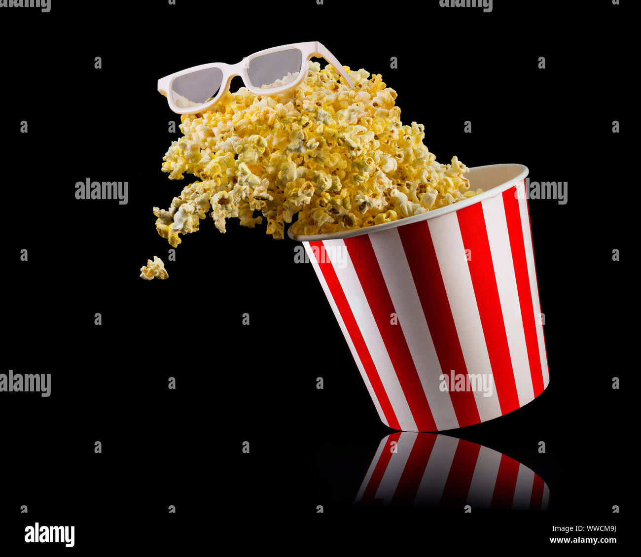 Flying popcorn from striped bucket isolated on black background Stock ...