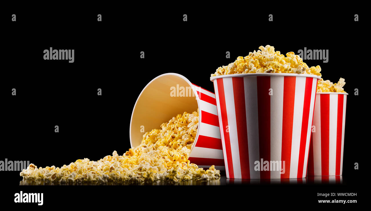 Set of paper striped buckets with popcorn isolated on black background ...
