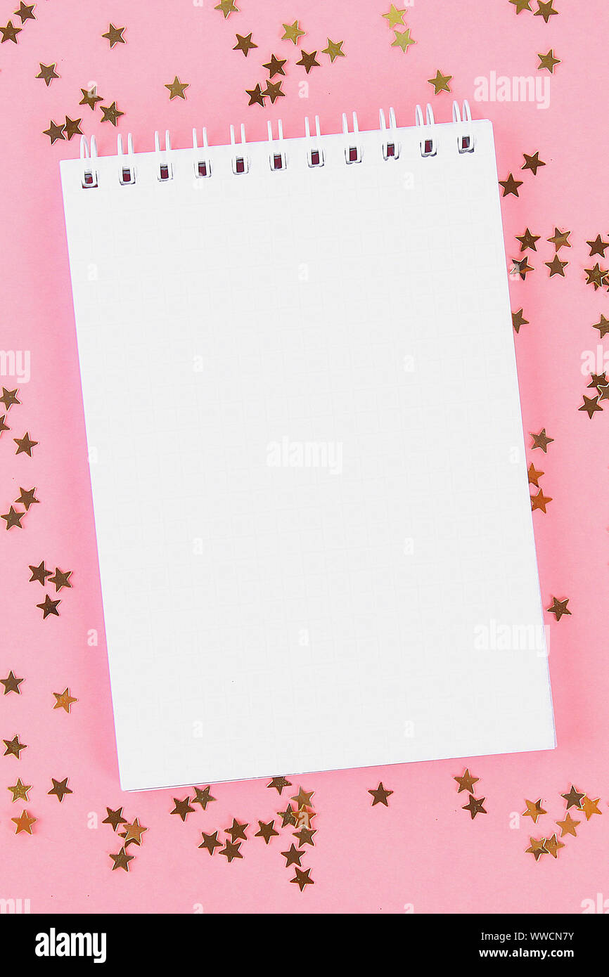 An empty pad on a pastel background surrounded by shiny decorative ...