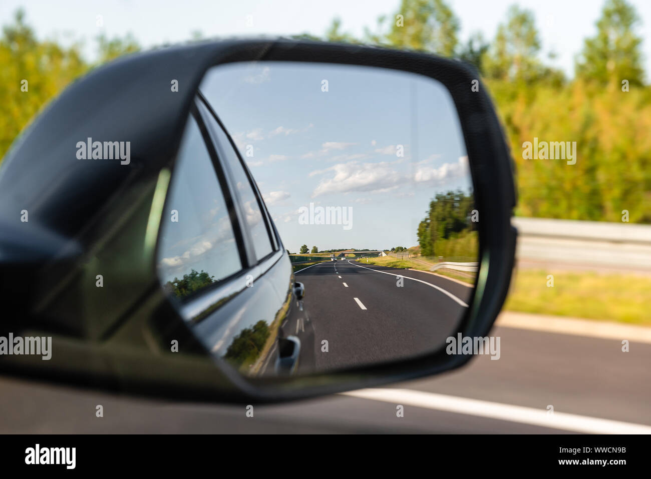 Asphalt road reflected in car mirror. Concept of safe driving Stock ...